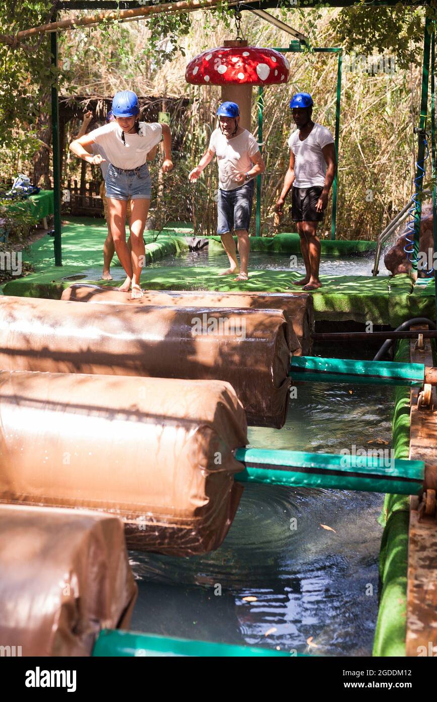 Men and women passing water obstacles Stock Photo - Alamy