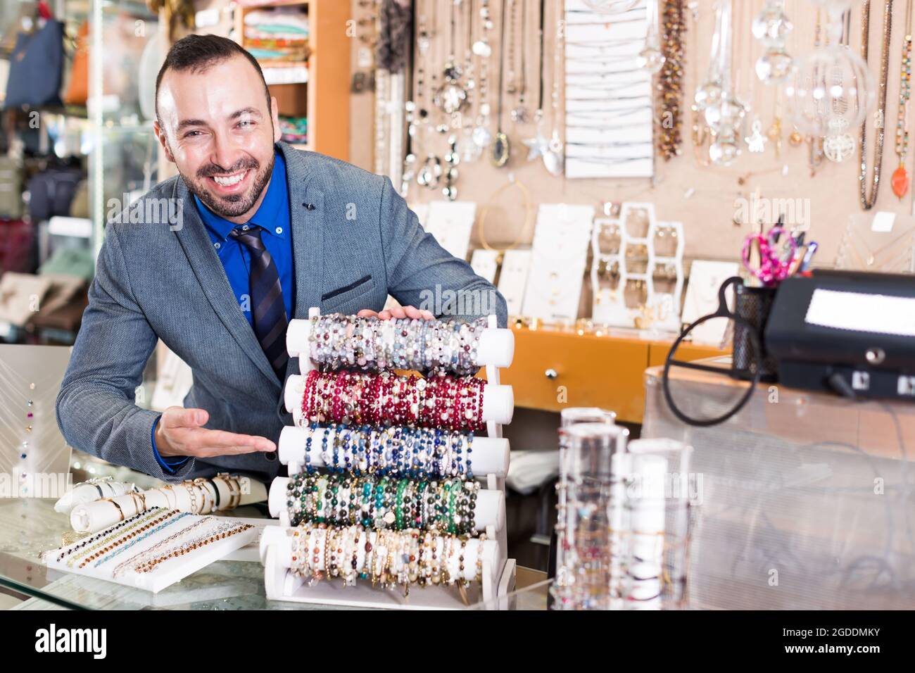 Man worker selling bracelets in jewelry store Stock Photo - Alamy