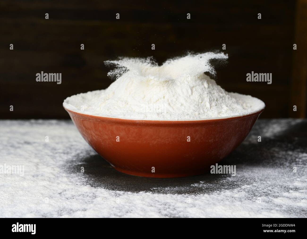 Flour in bowl on table on wooden background Stock Photo - Alamy