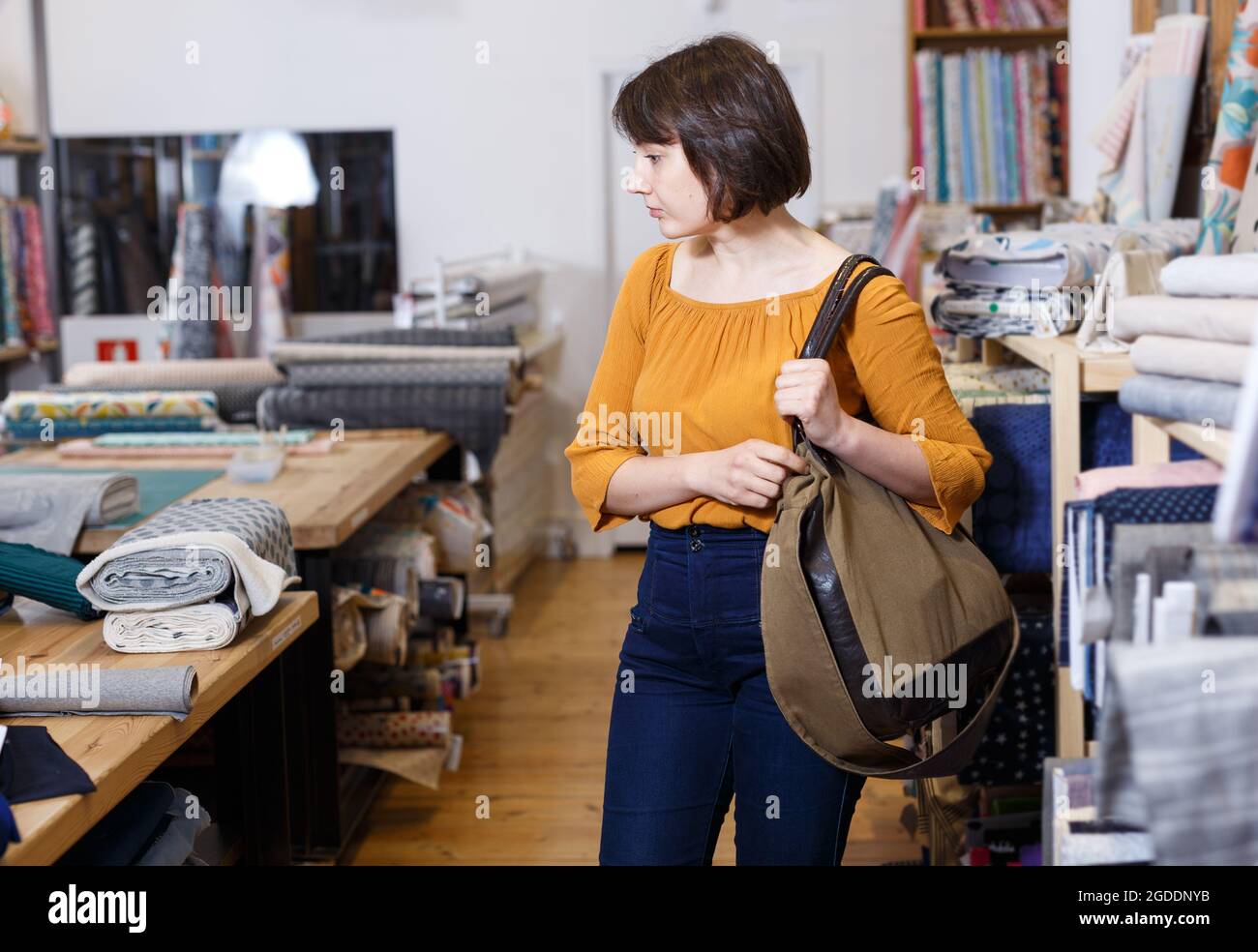 Thoughtful woman in fabric shop Stock Photo - Alamy