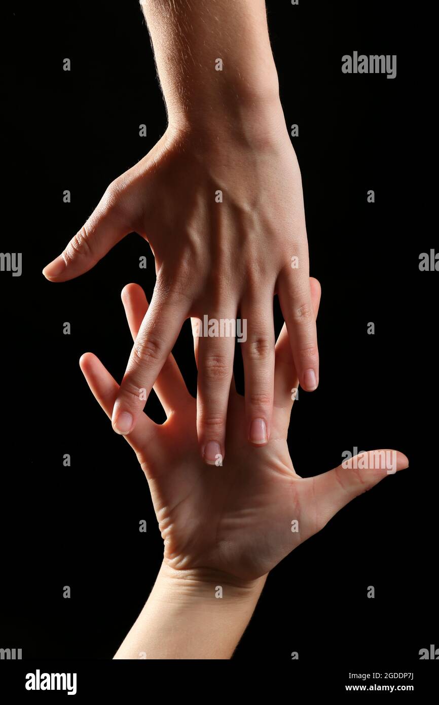 Human hands on black background Stock Photo - Alamy