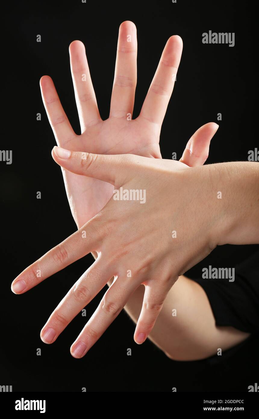 Human hands on black background Stock Photo - Alamy