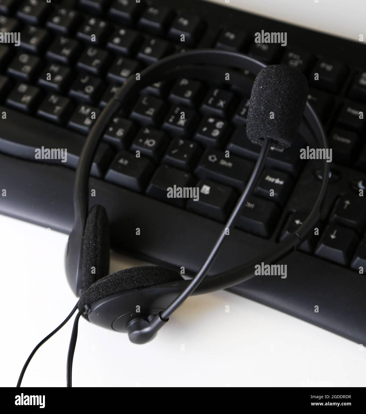 Headphone and keyboard close-up on white desk background Stock Photo ...