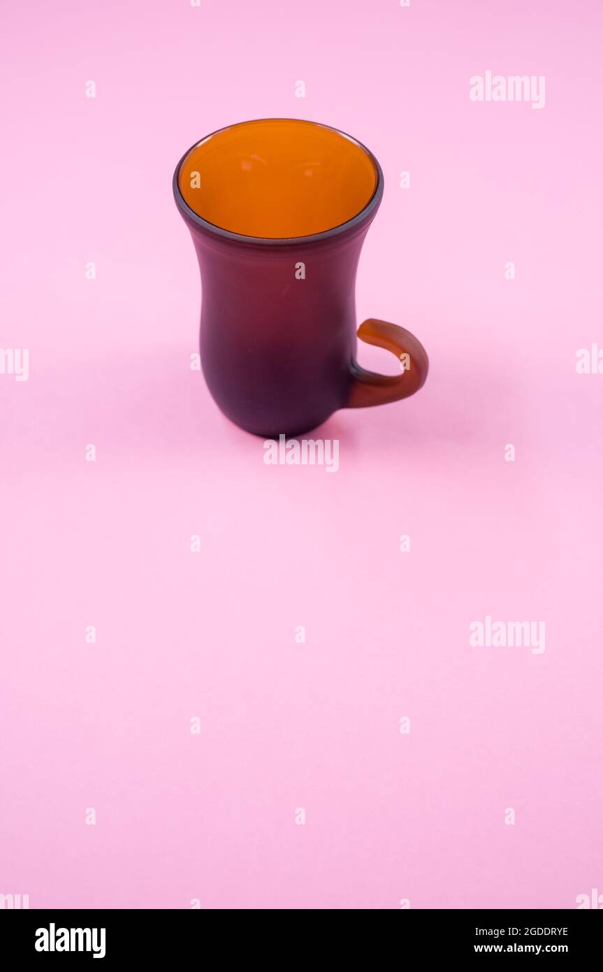 Vertical shot of brown bell-shaped mug isolated on pink background ...