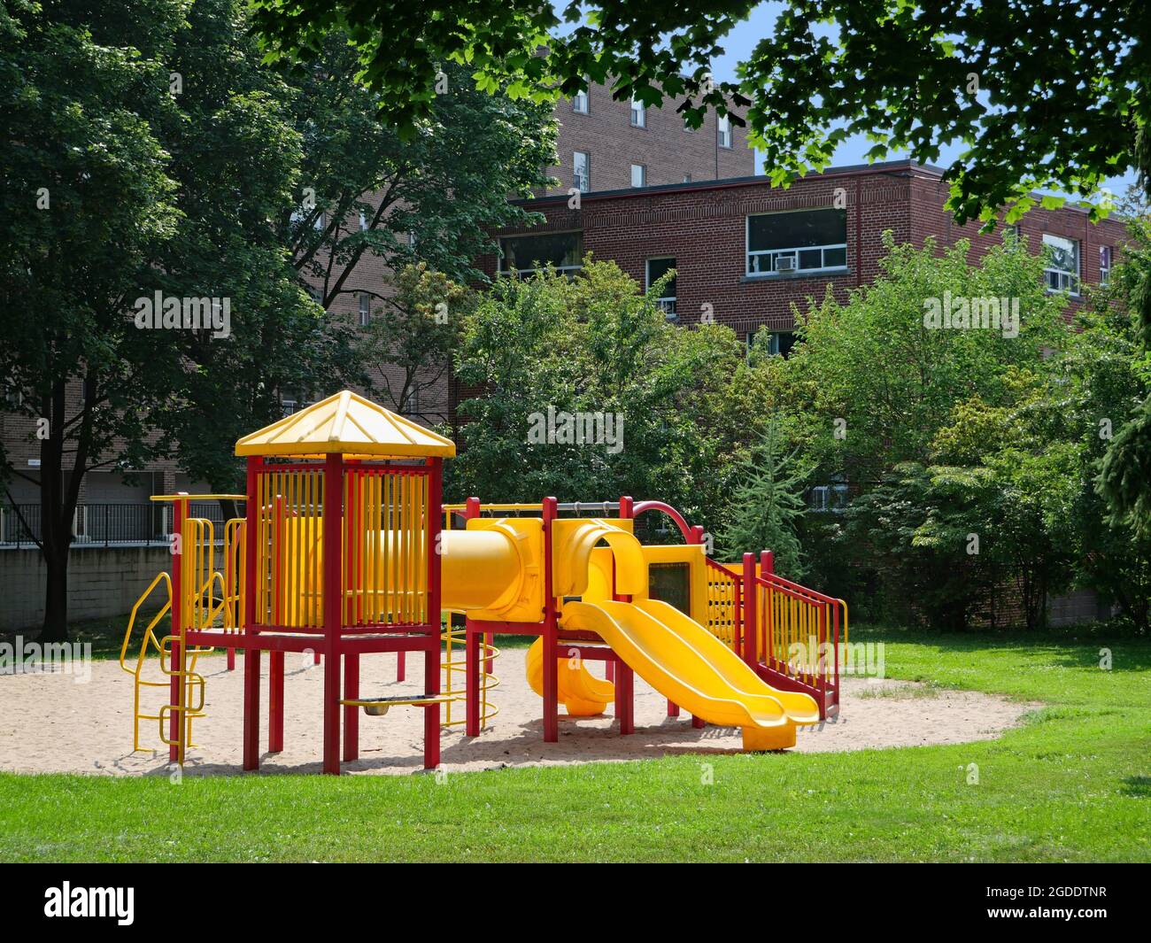 Brightly colored plastic playground equipment in a school yard Stock ...