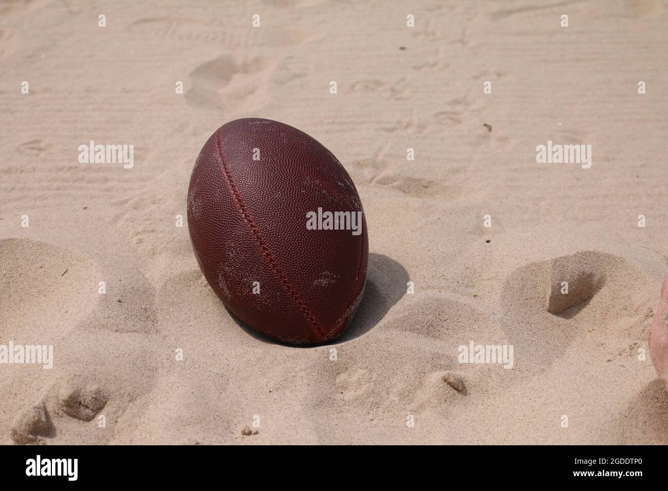 Football in the sand Stock Photo - Alamy
