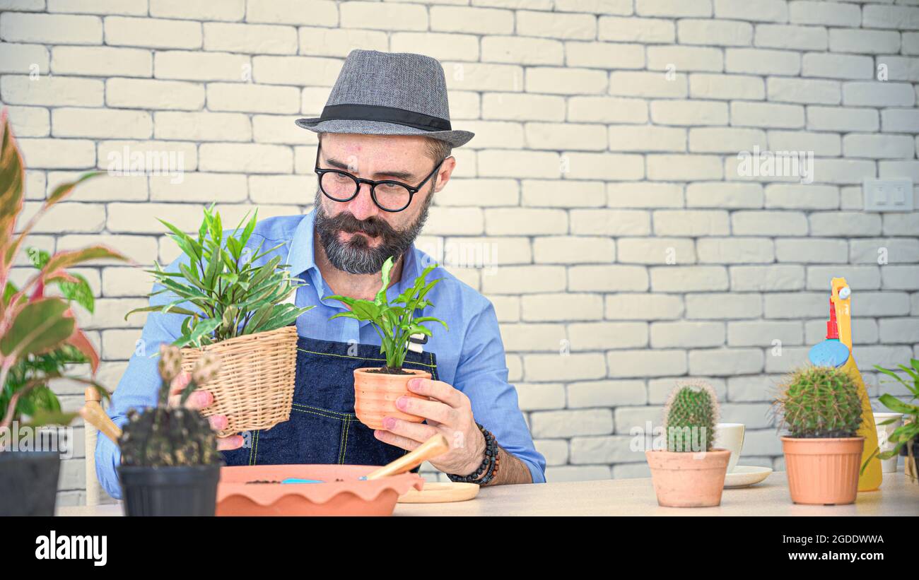 Relax hobbies lifestyle of Caucasian male wearing apron planting in the ...