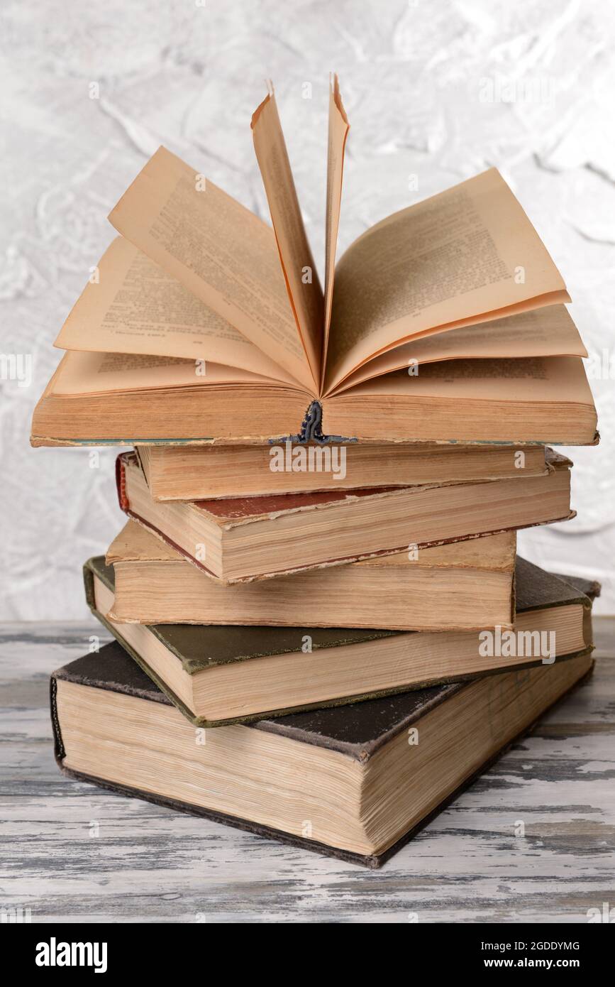 Old books on table on grey background Stock Photo - Alamy