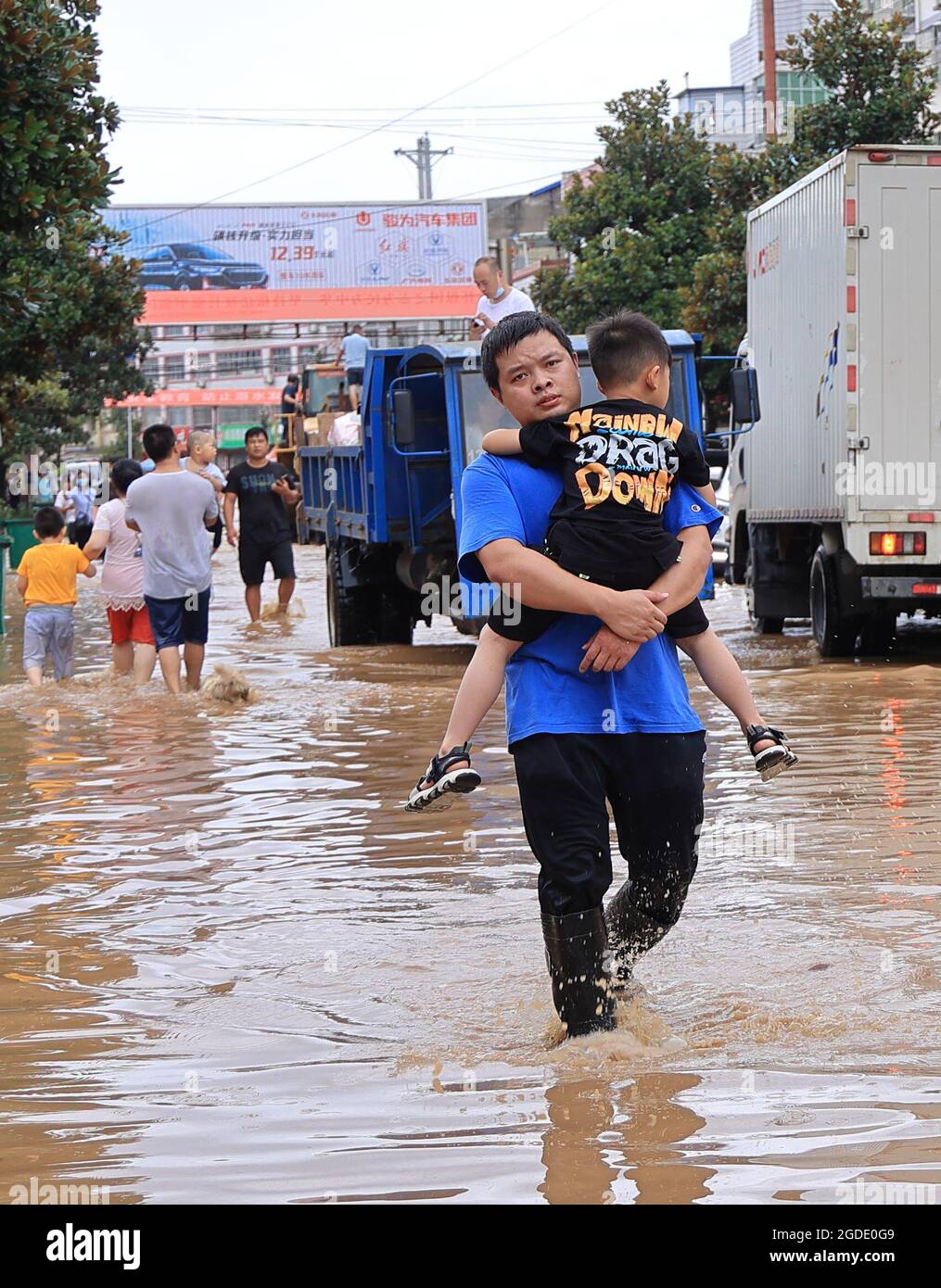 SUIZHOU, CHINA - AUGUST 12, 2021 - A father and his son head to a ...