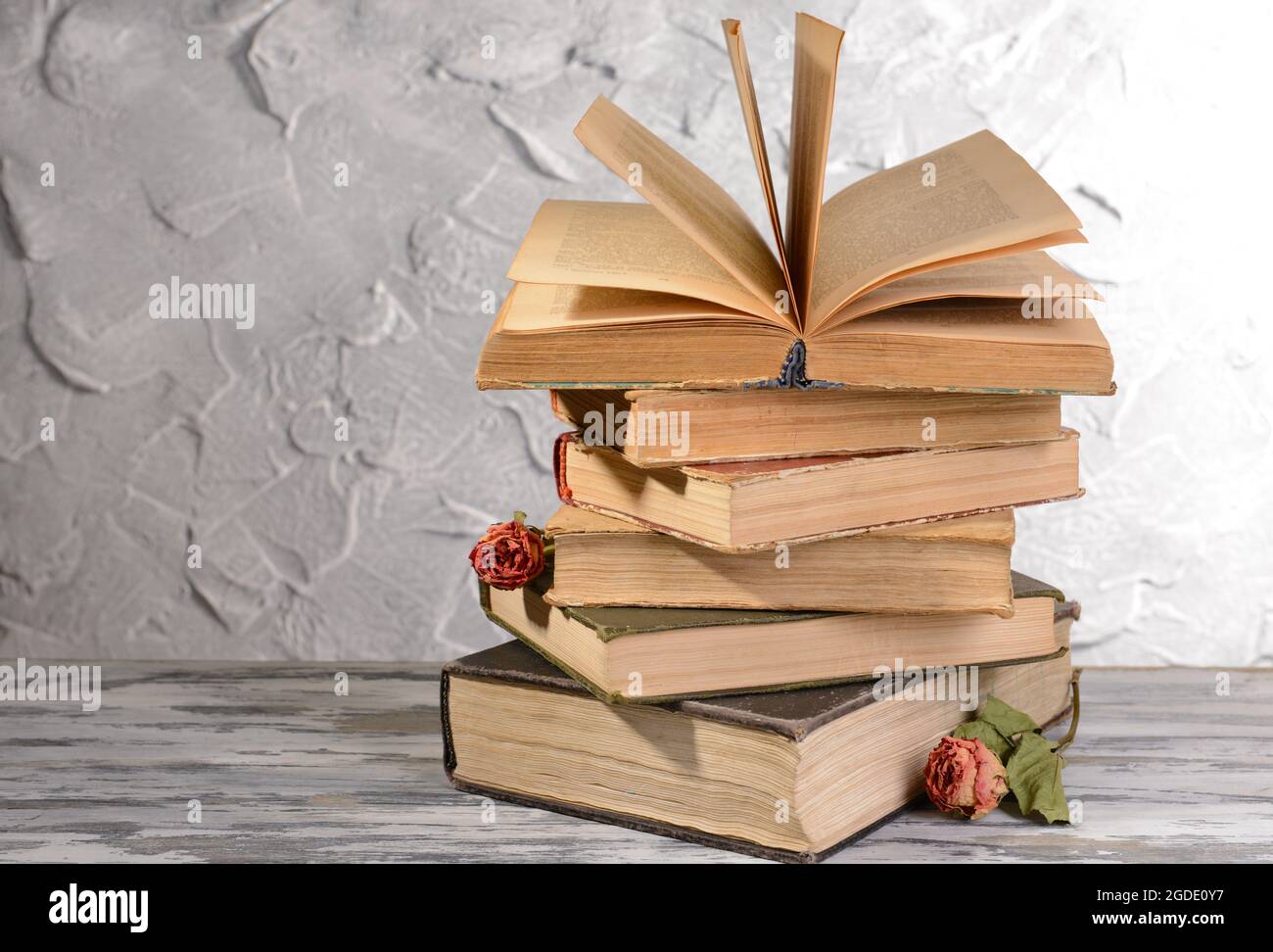 Old books on table on grey background Stock Photo - Alamy
