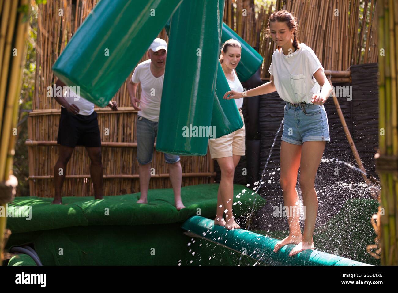 People passing crossbar with obstacles Stock Photo - Alamy