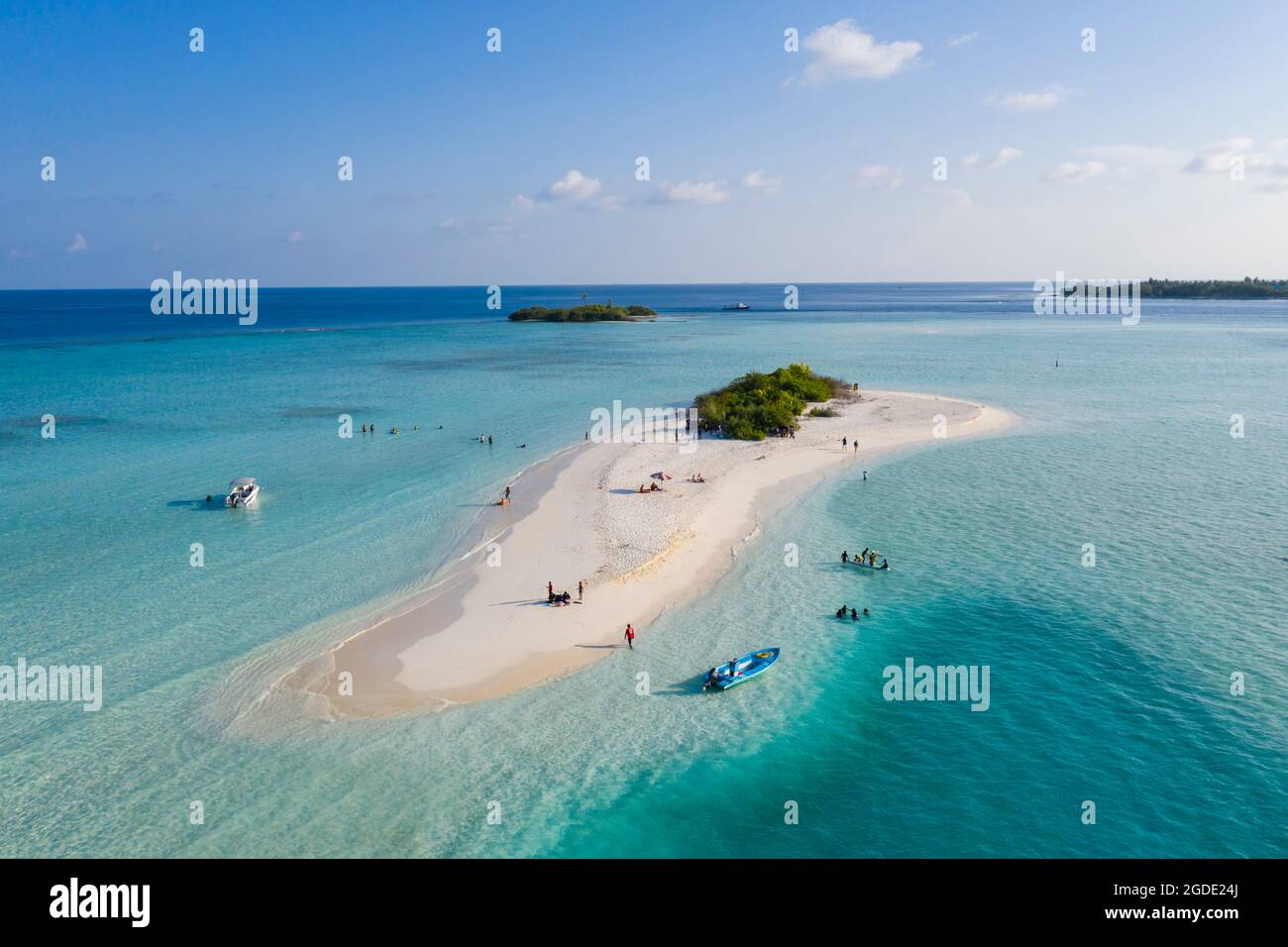 Aerial view of travelers on a small sandy island in the Indian Ocean ...