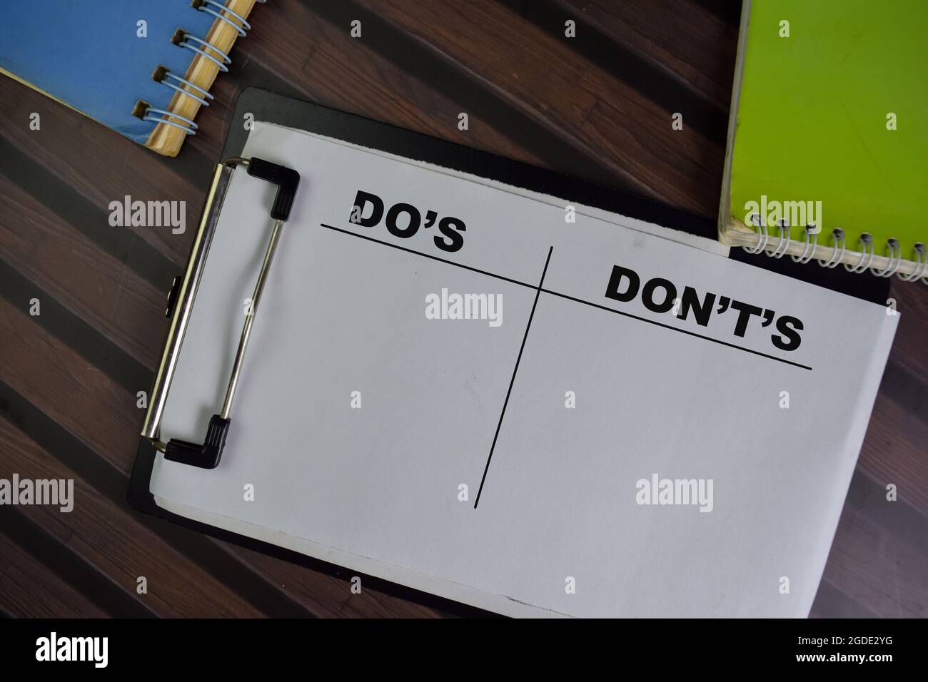 Do's and Don't's write on a paperwork isolated on Wooden Table Stock ...