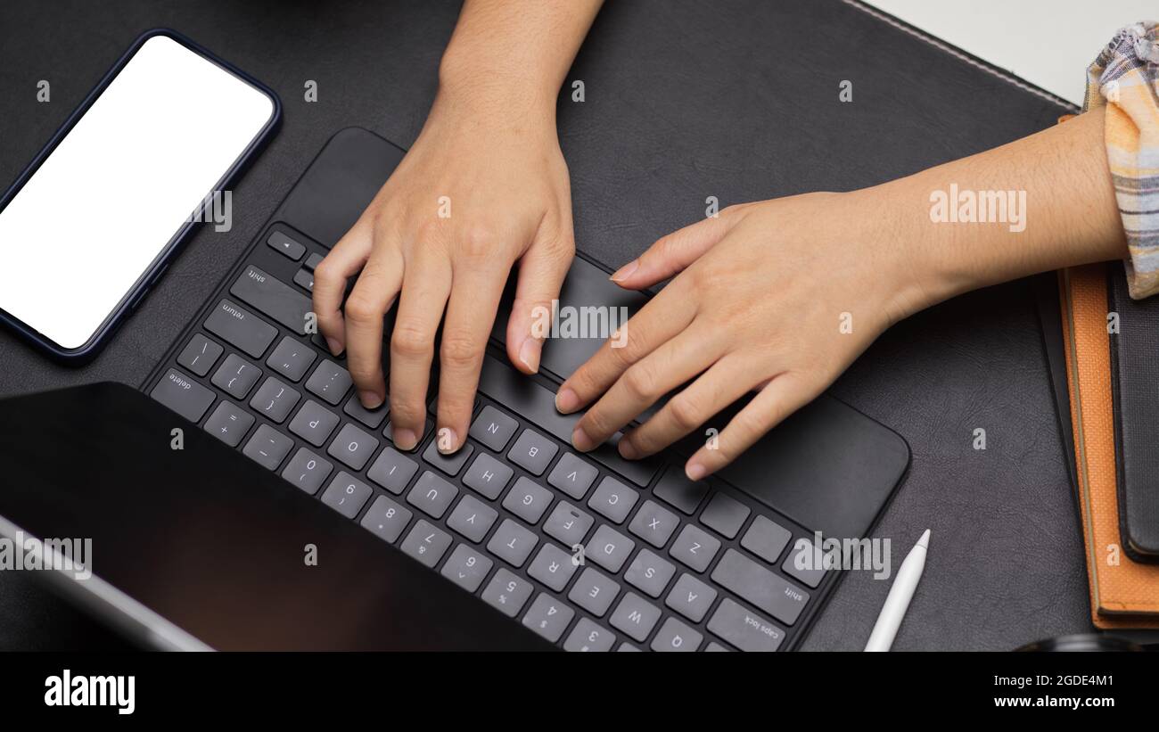 Female blogger using portable tablet to create new content, closeup ...