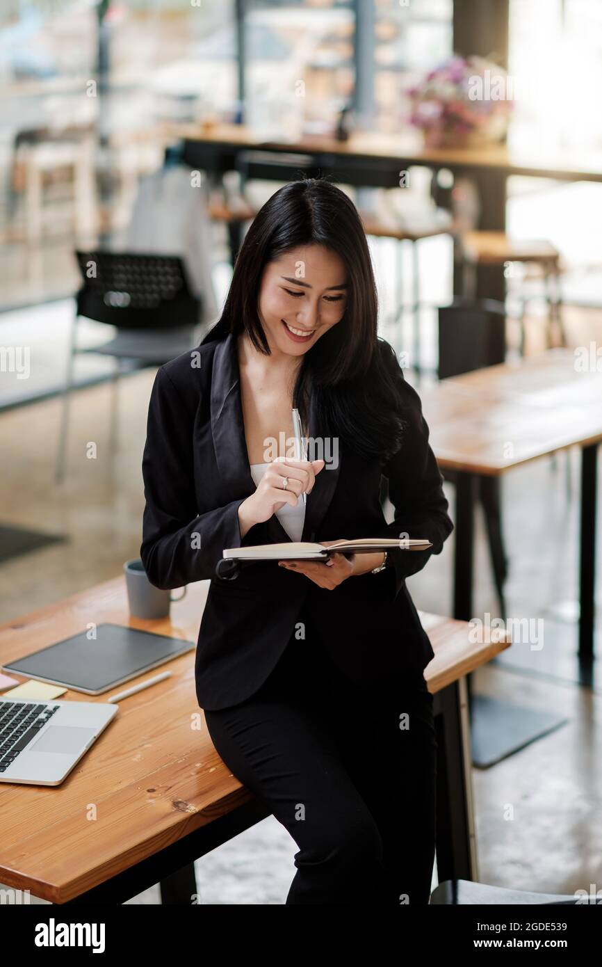 Portrait asian business woman working at office and taking note, Female ...