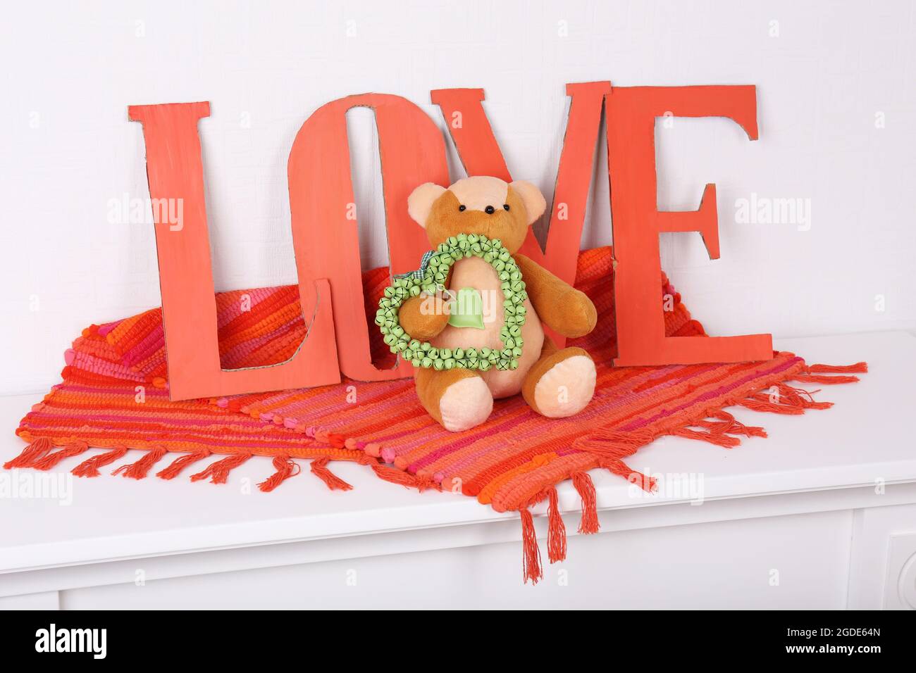 Decorative letters forming word LOVE with teddy bear on wall background ...