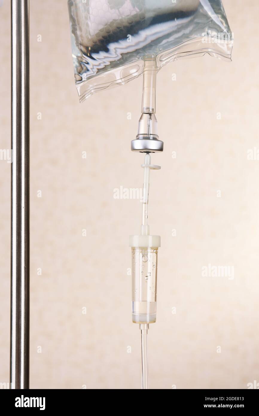Disposable infusion set on wall background Stock Photo - Alamy