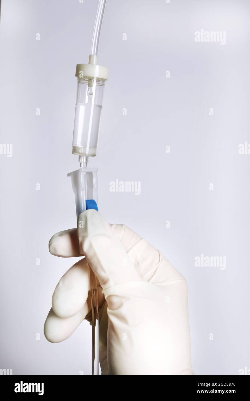 Disposable infusion set on grey background Stock Photo - Alamy