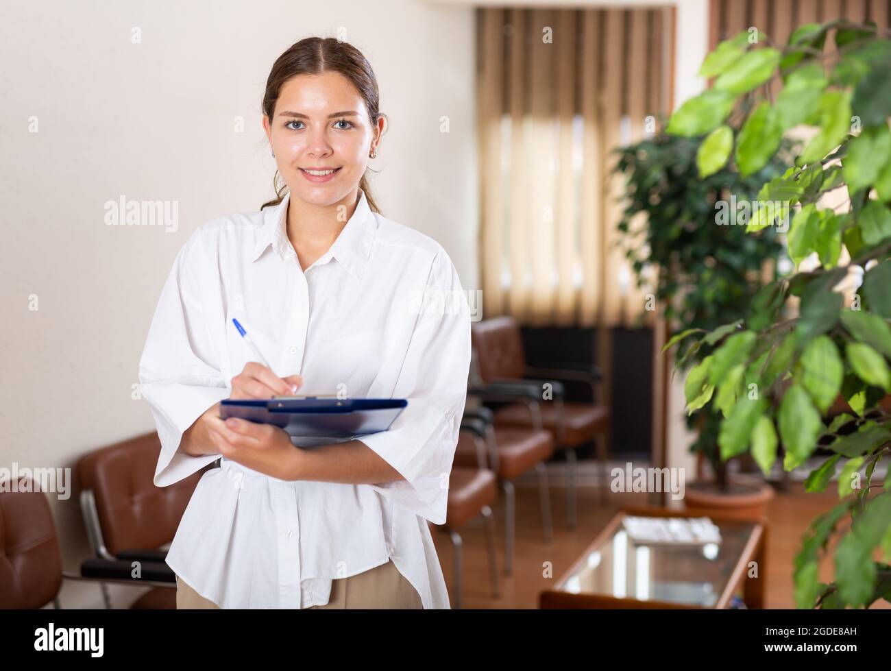 Portrait of woman holding folder in hands Stock Photo - Alamy