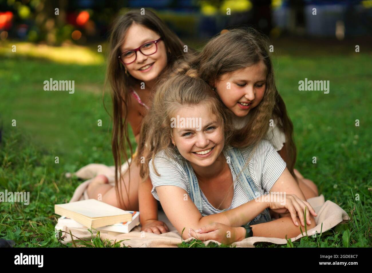 Three smiling playful Sisters having fun outdoor. Sisters Together ...