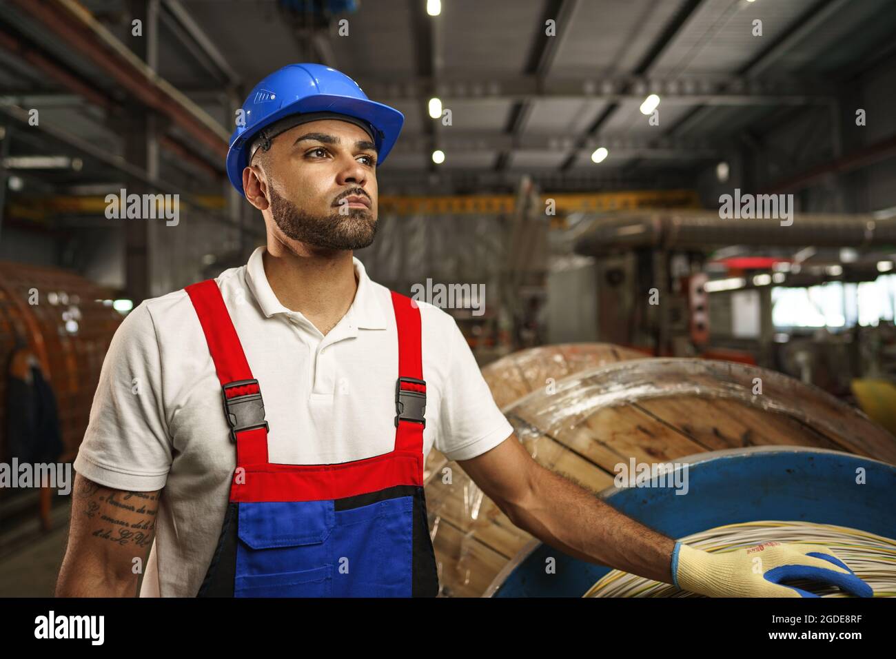 Portrait of african american male handyman working in an industrial ...