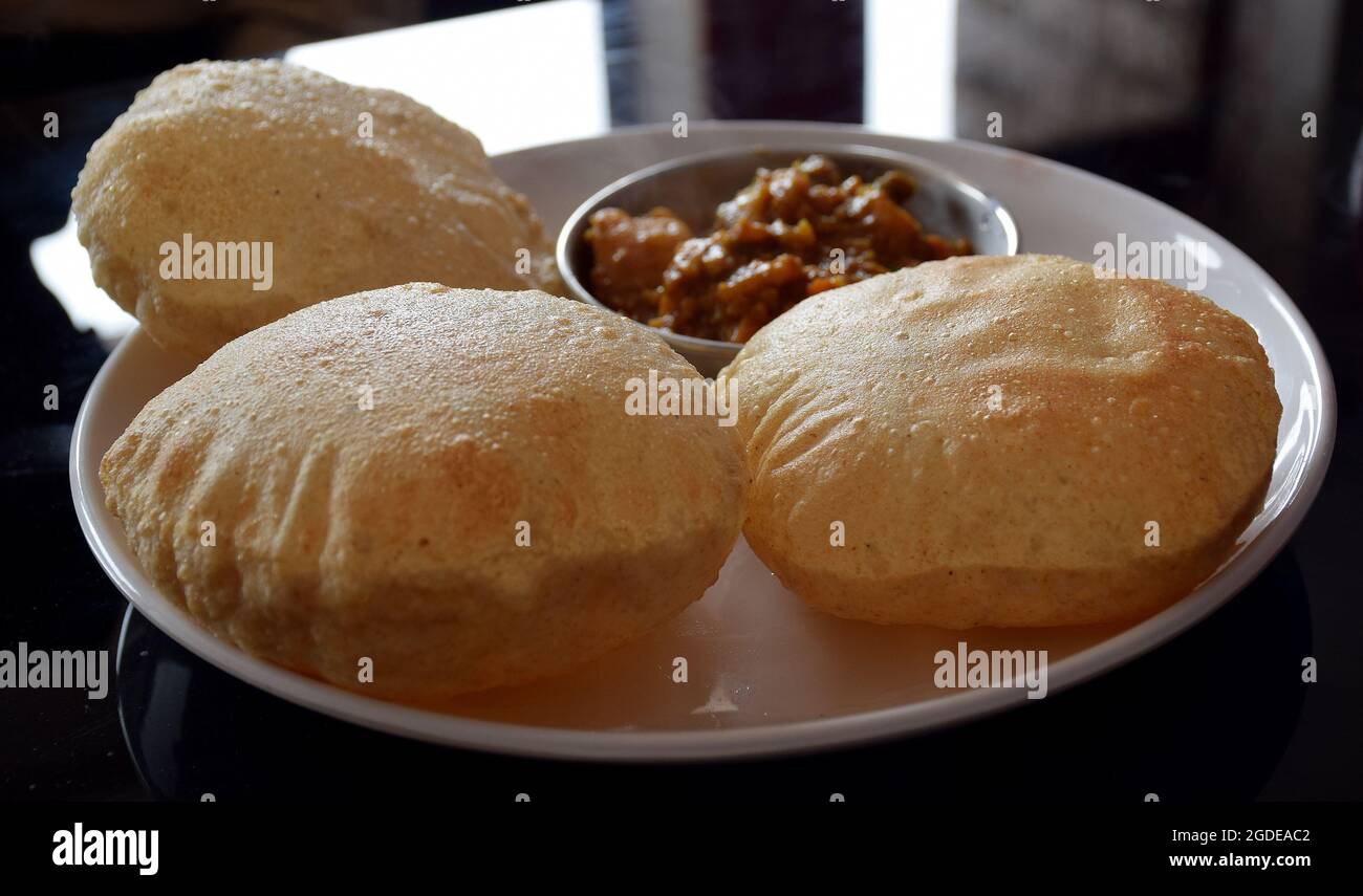 Indian breakfast poori (deep fried bread) at a restaurant Stock Photo ...