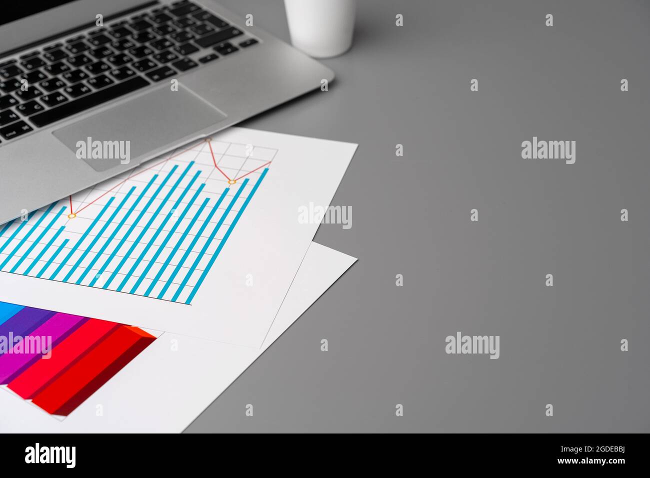 Financial report and laptop on business desk Stock Photo - Alamy