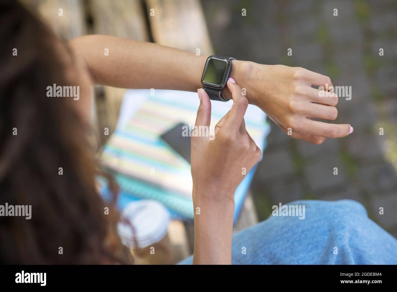 A girl with a smartwatch on her wrist Stock Photo - Alamy