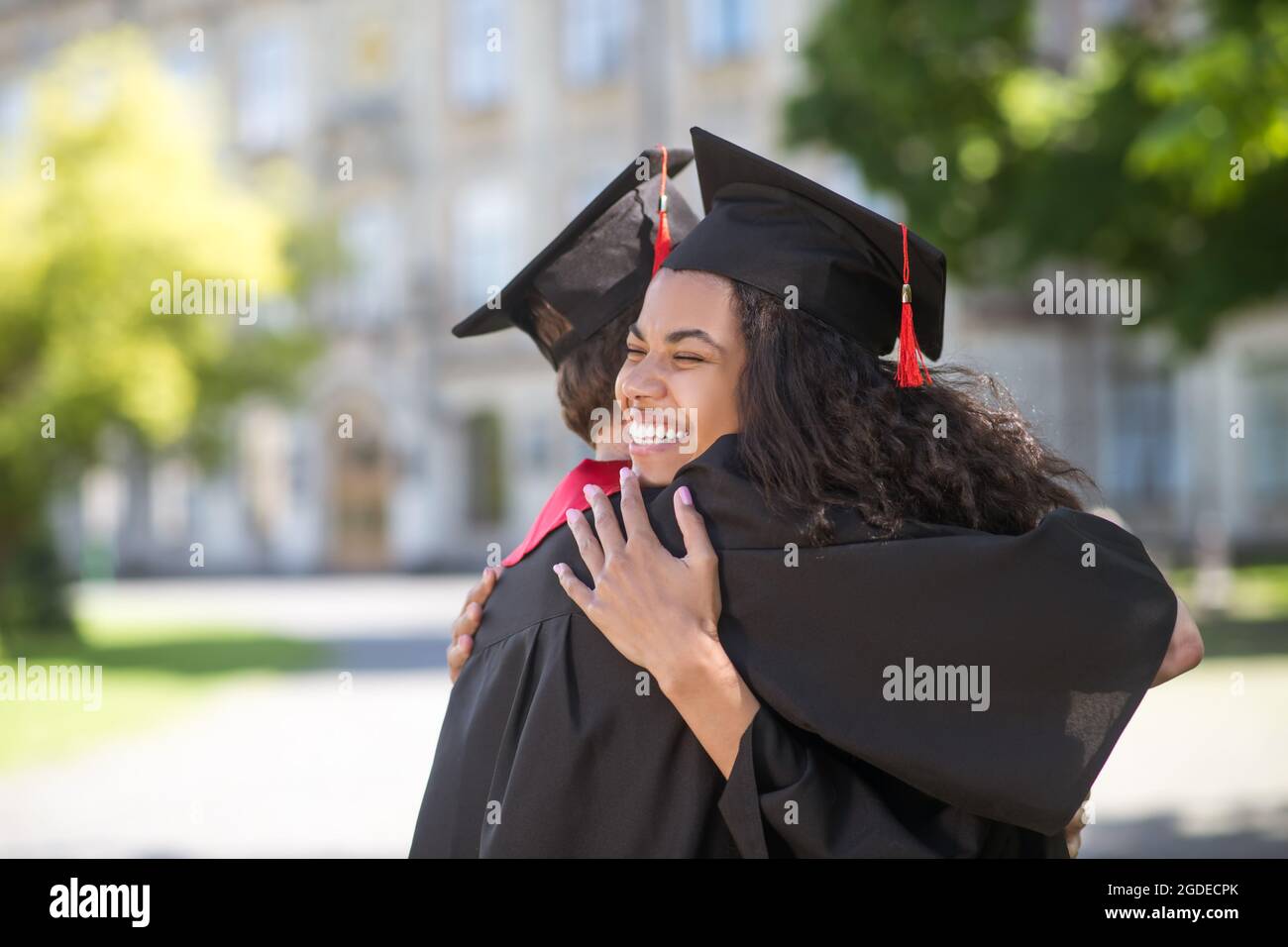 Friends hugging each other after graduation and feeling happy Stock ...