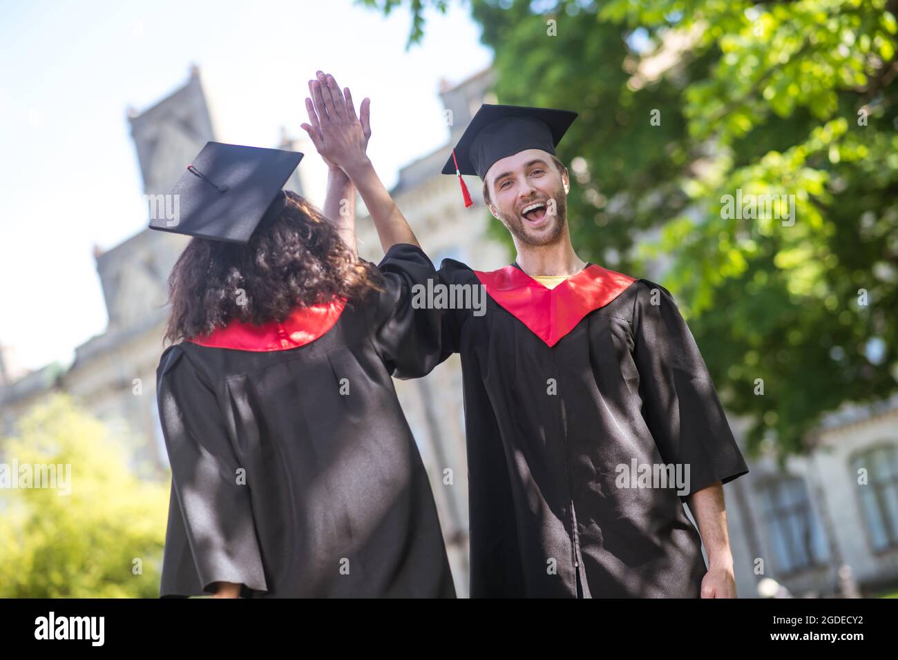Two graduates feeling excited after graduation and looking happy Stock ...