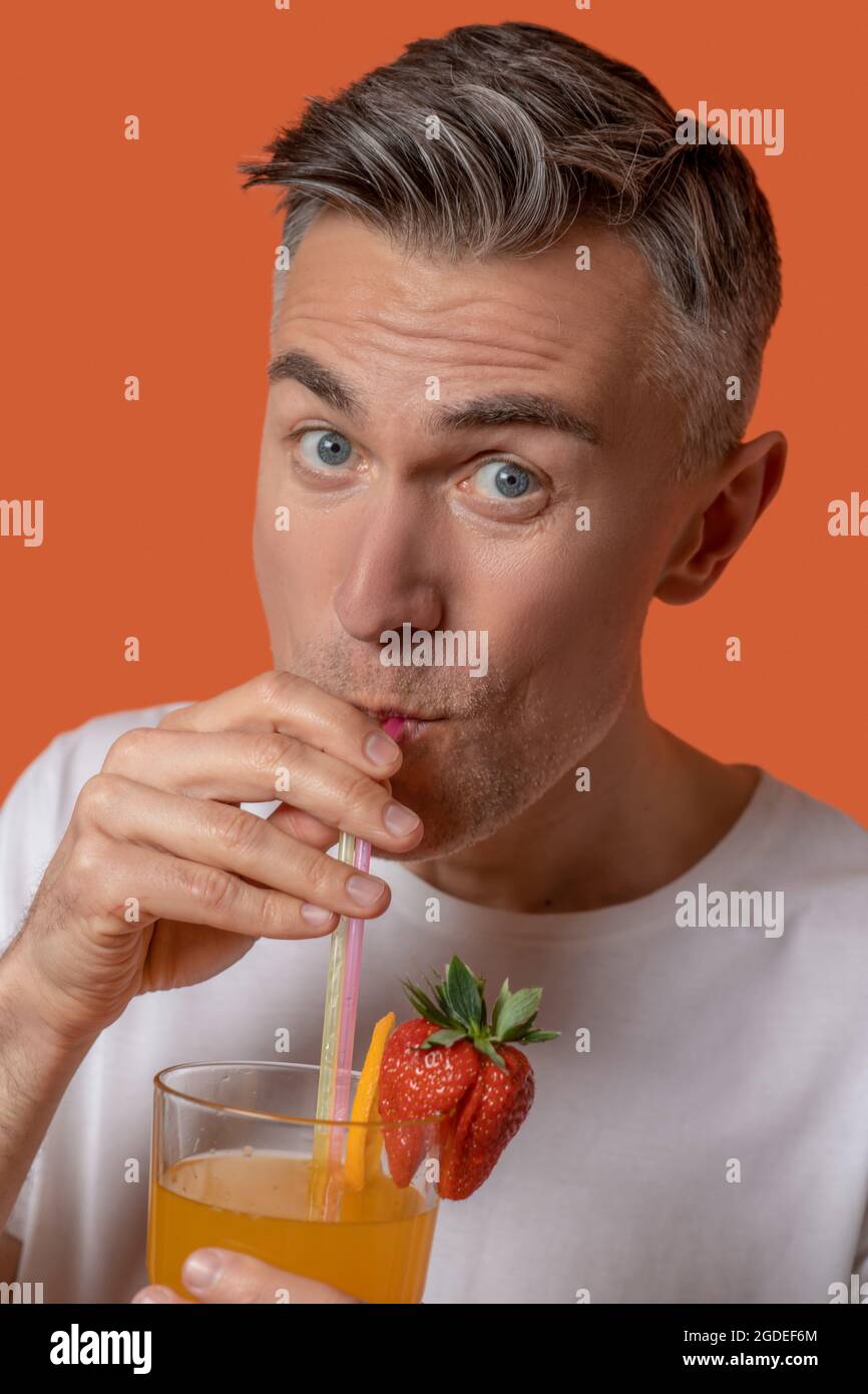 Man drinking straw orange juice hi-res stock photography and images - Alamy