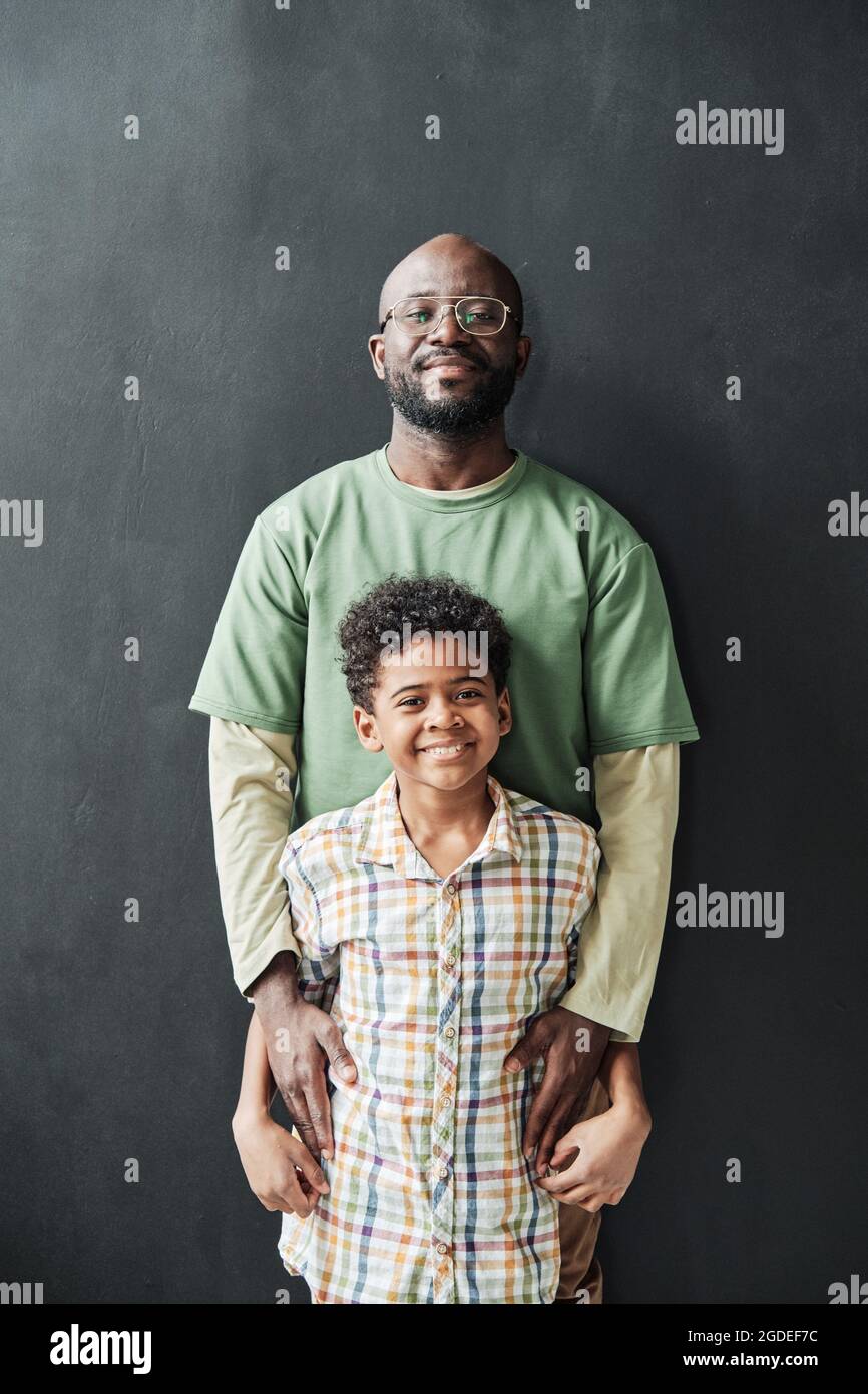 Portrait of African father smiling at camera together with his little ...