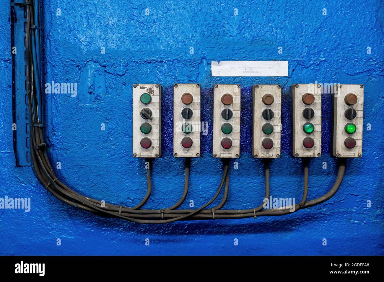 sensor on the blue wall, wires, cables, green light Stock Photo - Alamy