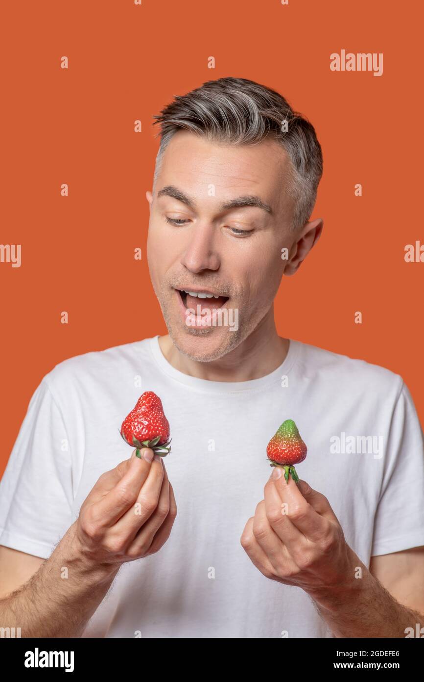 Strawberry in mouth hi-res stock photography and images - Alamy