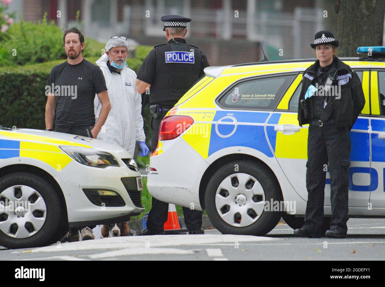 A police investigator alongside uniformed officers in Royal Navy Avenue ...