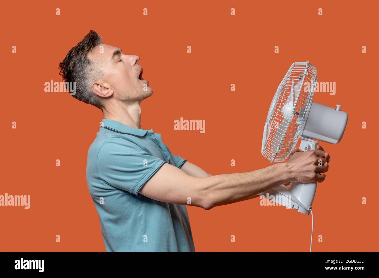 Profile of man holding fan in his hands Stock Photo - Alamy