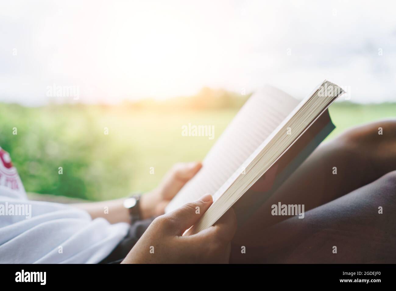 Woman is reading book in beautiful park and pond relax and peaceful ...