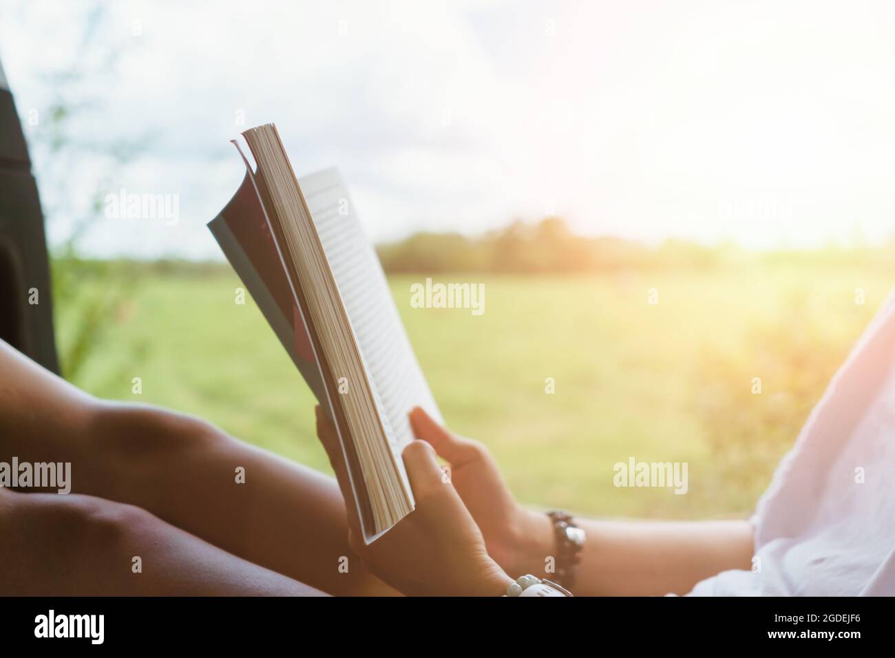 Woman is reading book in beautiful park and pond relax and peaceful ...