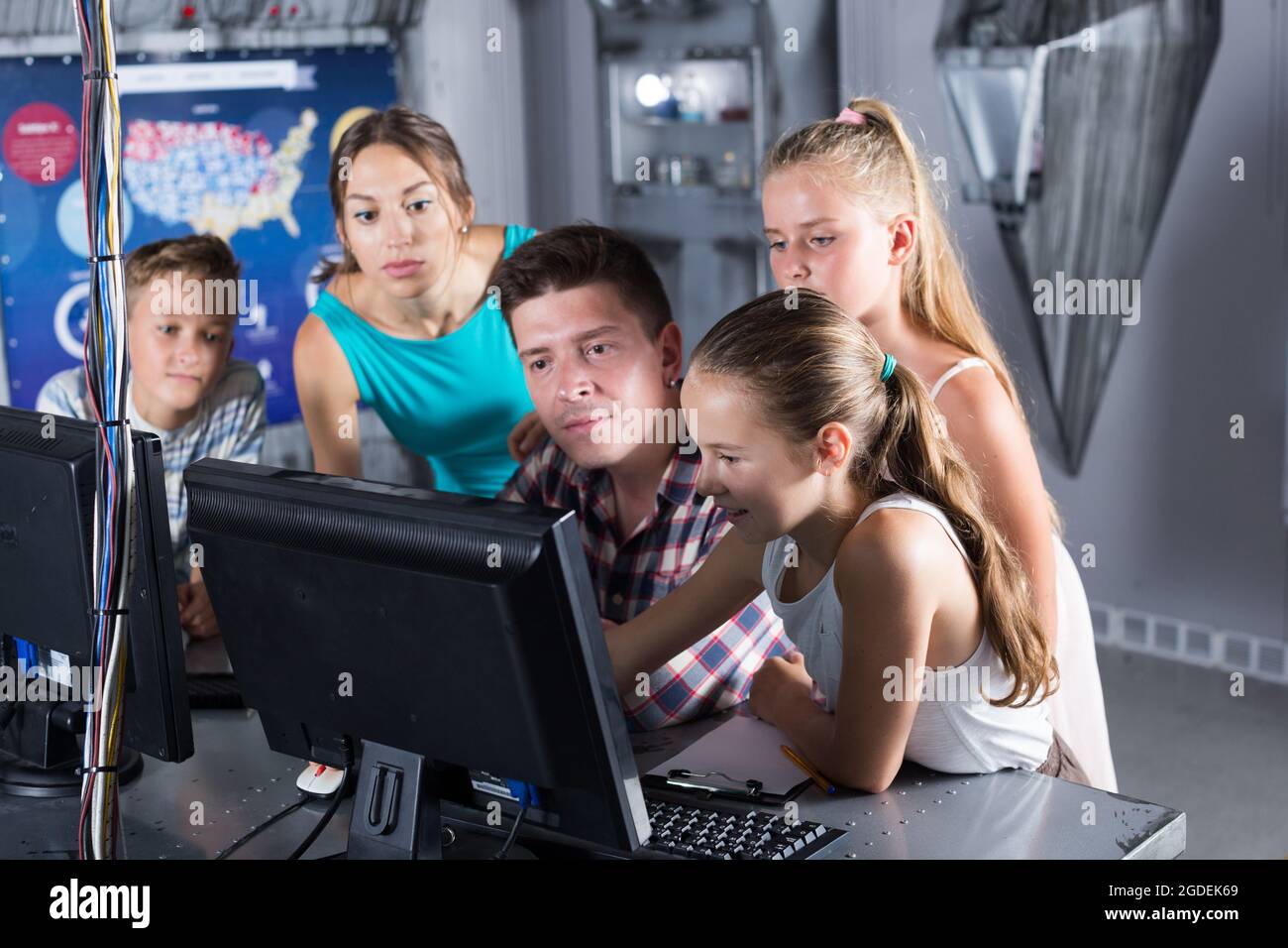 Parents with their children are using PC in time having fun together ...