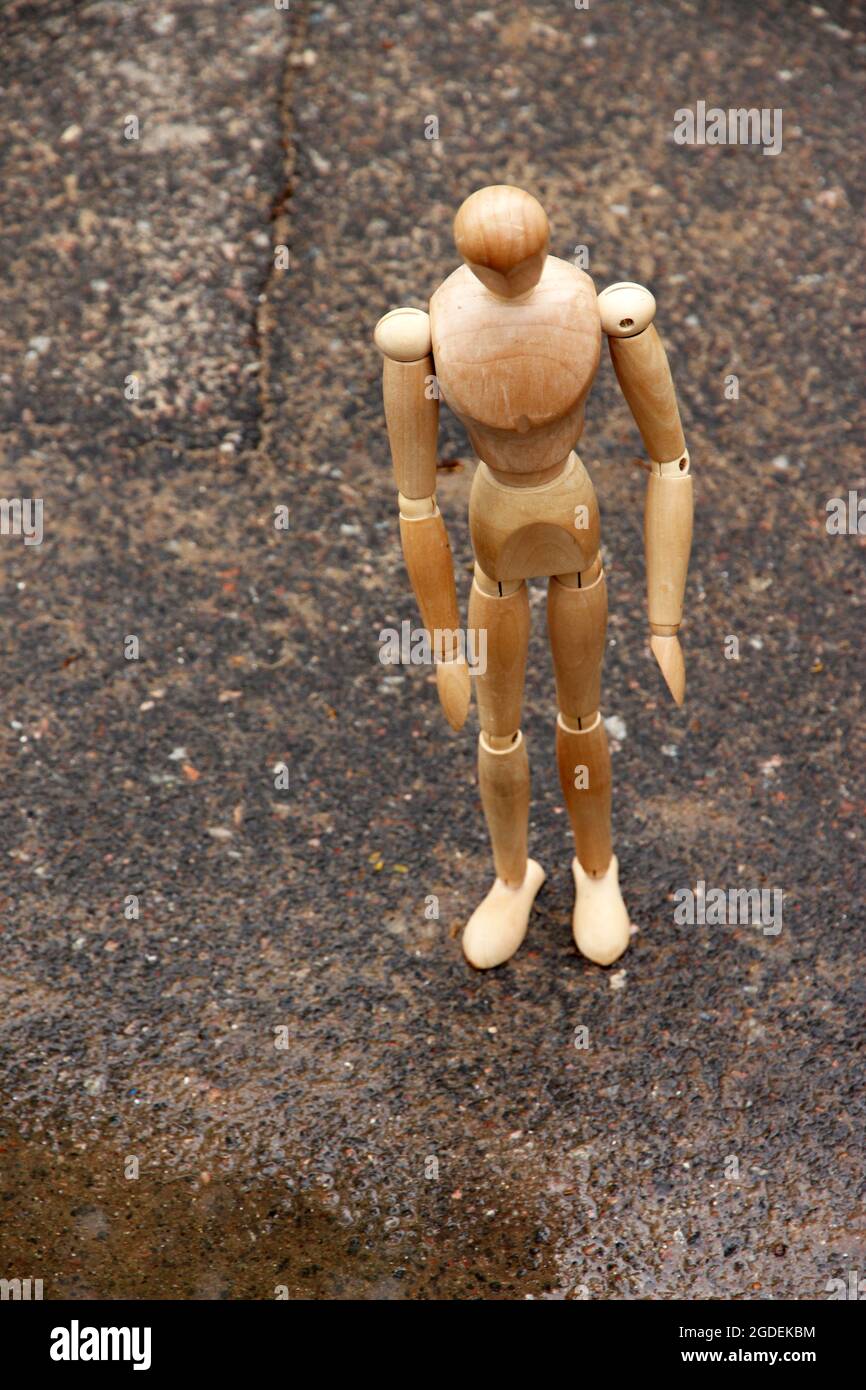 Wooden pose puppet under rain, outdoors Stock Photo - Alamy