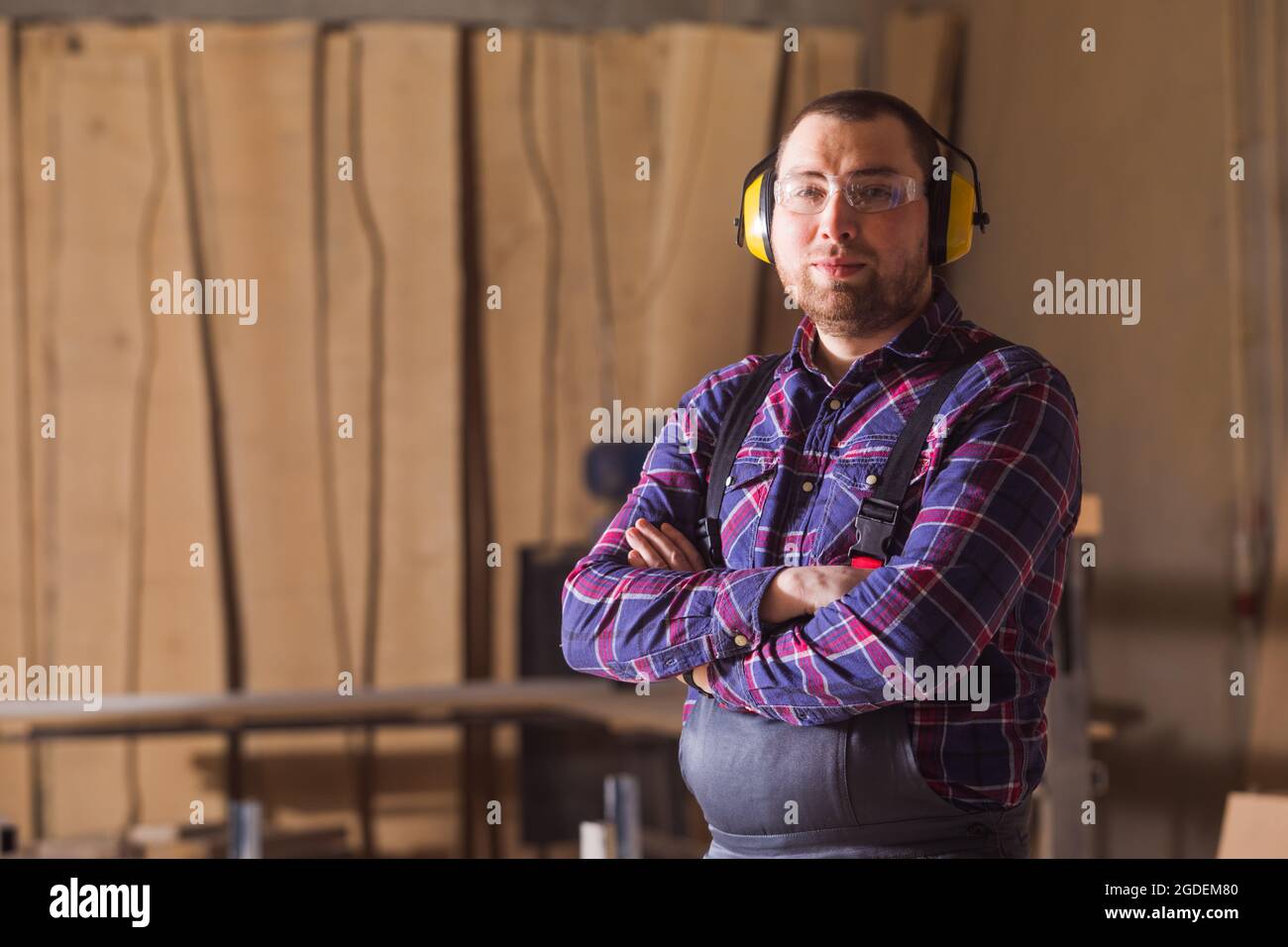 the carpenter wearing safety clothes in the factory Stock Photo - Alamy