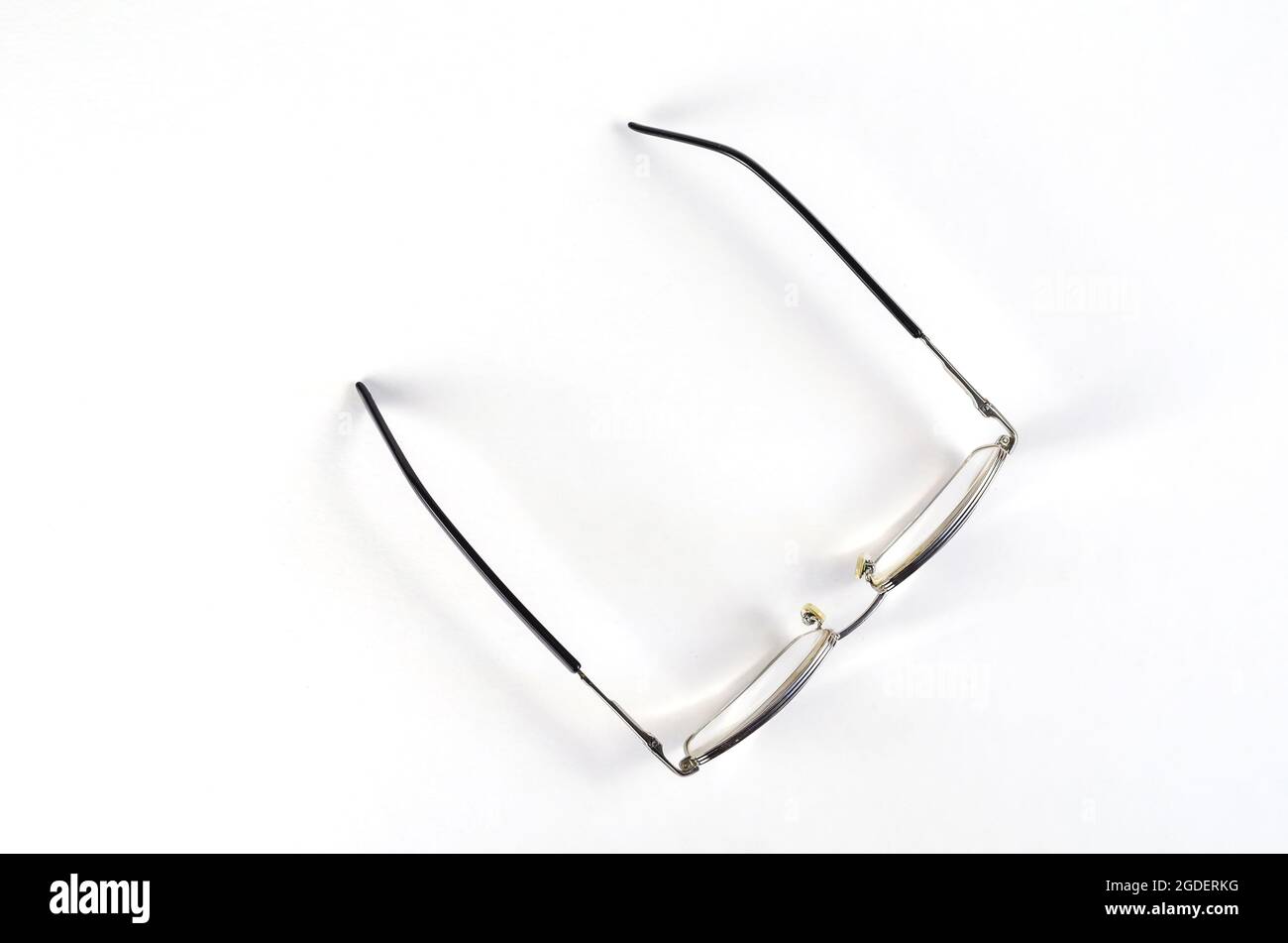 Reading glasses on a white background. Metal-rimmed glasses with ...