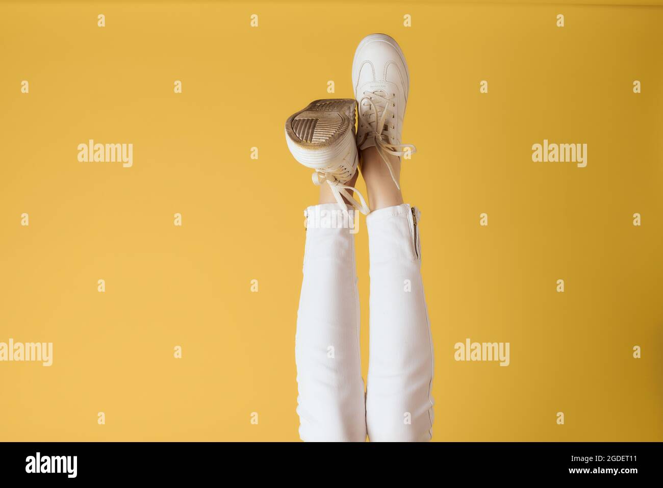 womens inverted legs upside down white sneakers fashion Stock Photo - Alamy