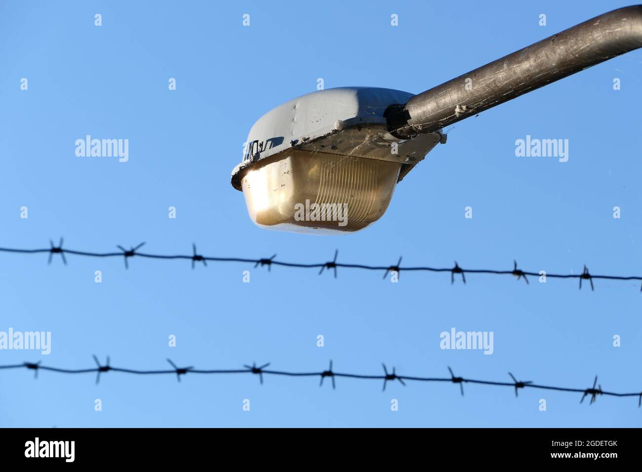 Safety and security at the facility. Barbed wire and spotlight Stock ...