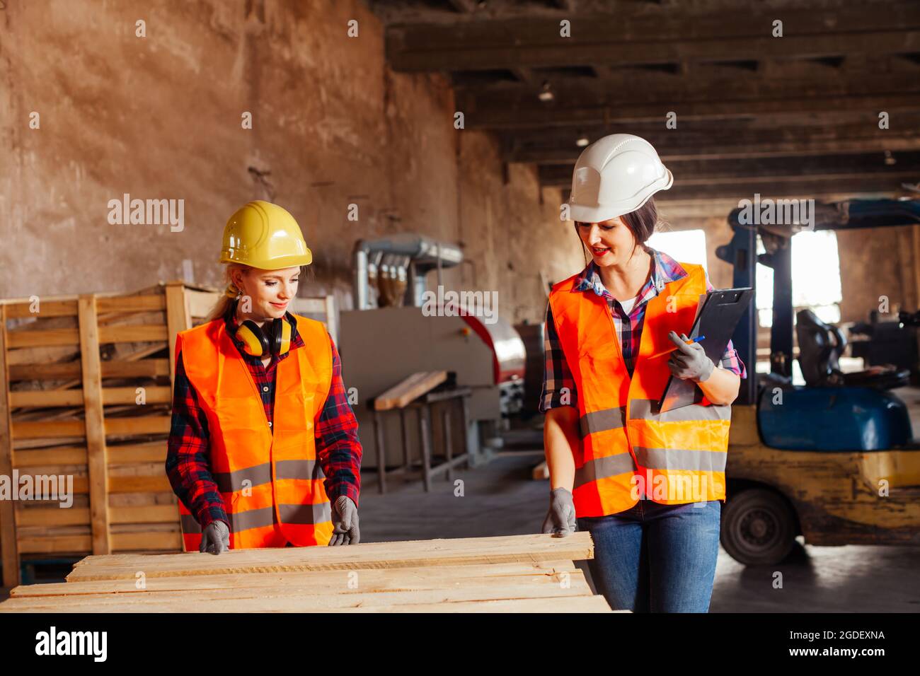 The young women in uniform working in a factory Stock Photo - Alamy