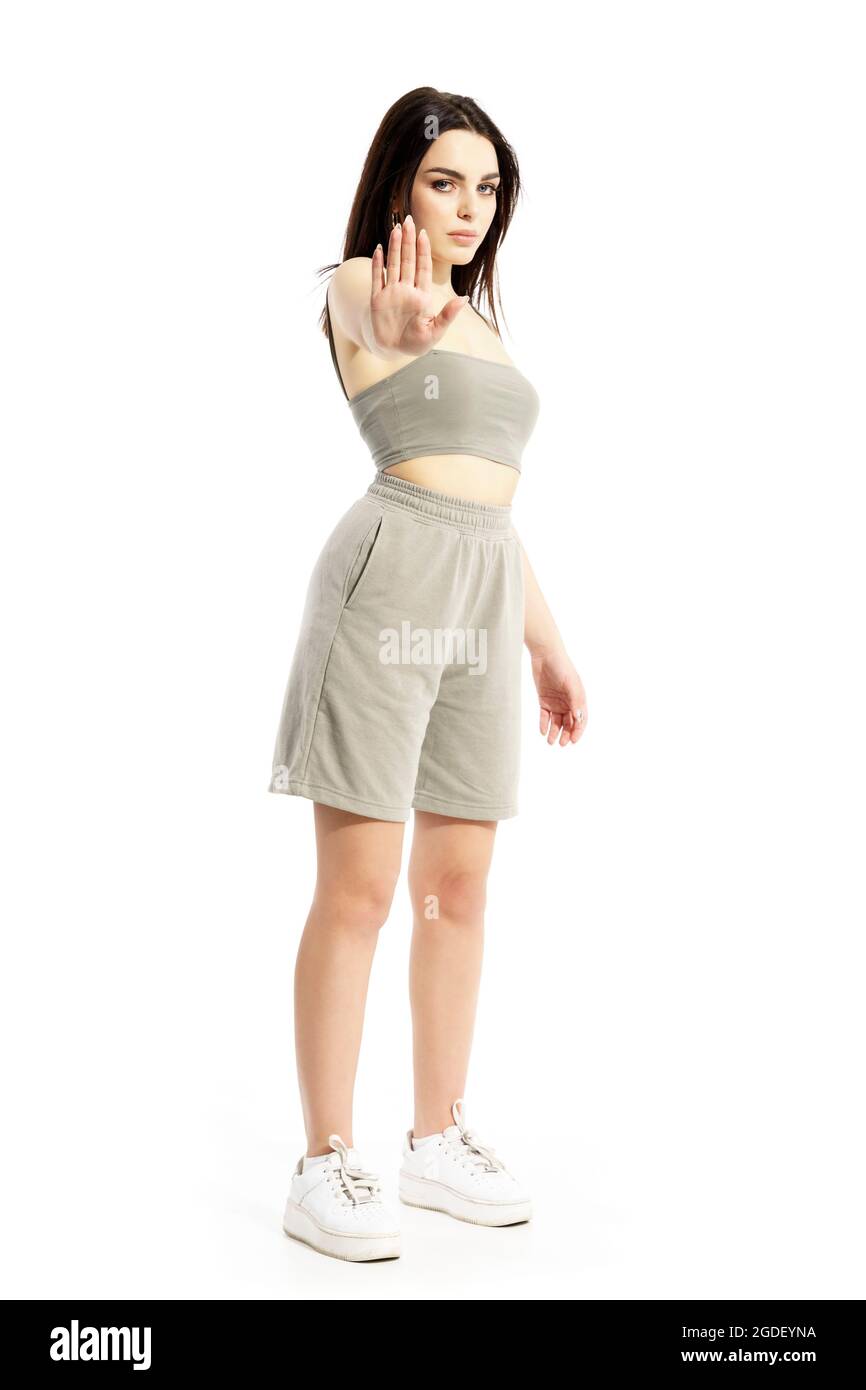 Serious young stylish gen Z woman showing stop or rejection hand sign ...