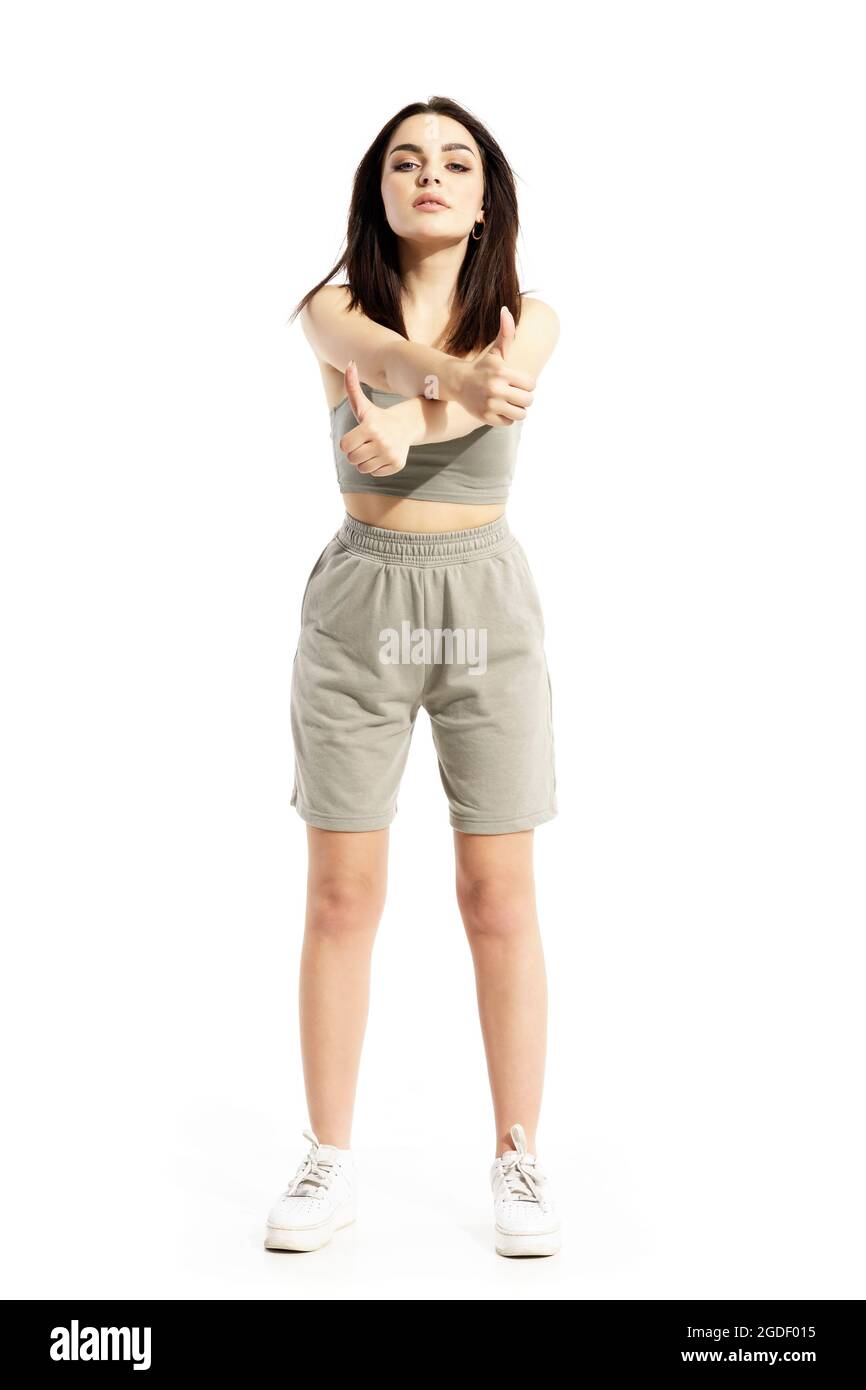 Cocky attitude young beautiful summer woman showing thumbs up with ...