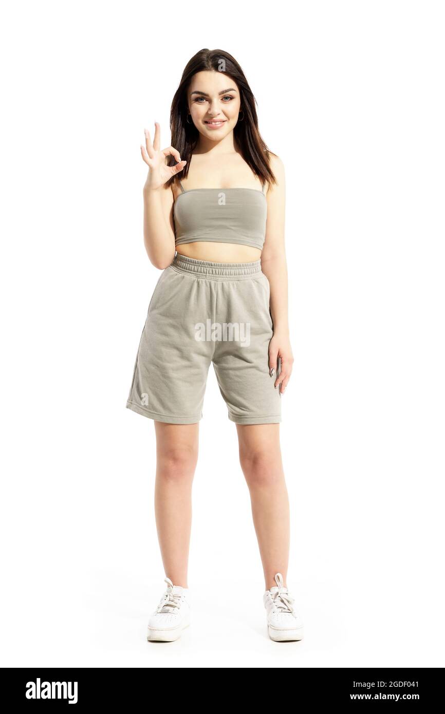 Happy cool stylish summer young woman showing delicious hand gesture ...