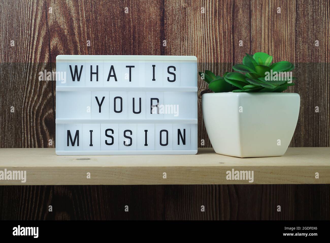 What is your mission? text on light box standing on wooden shelf and ...