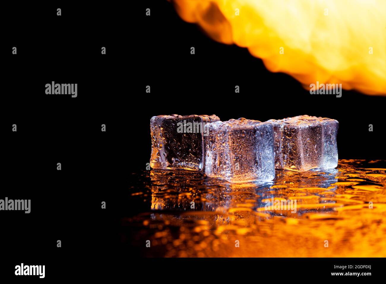 three ice cubes against the background of fire, fire and ice, place ...